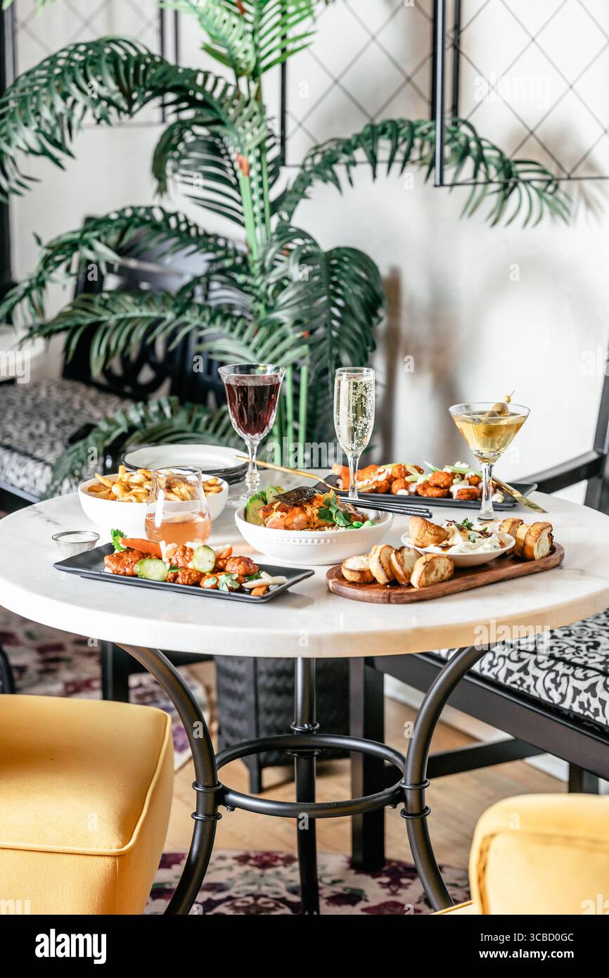 Elegant restaurant table set with drinks, appetizers, and décor Stock ...