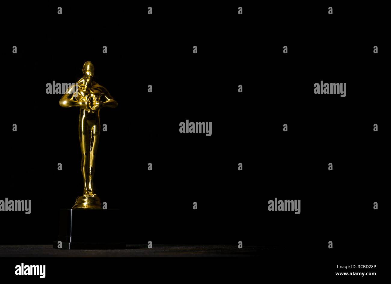 Hollywood Golden Oscar Academy award statue against black background ...