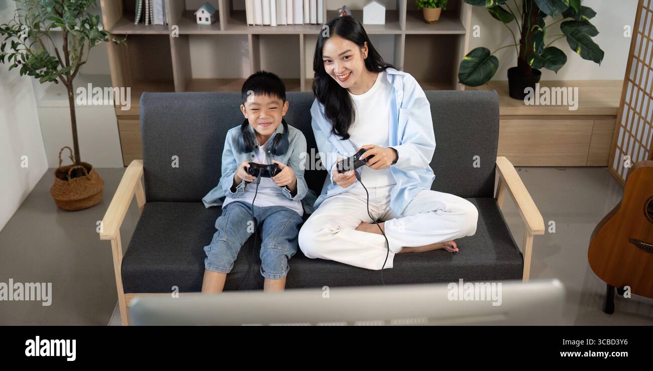 Gaming Fun: Mother and Son Playing Video Games Stock Photo - Alamy