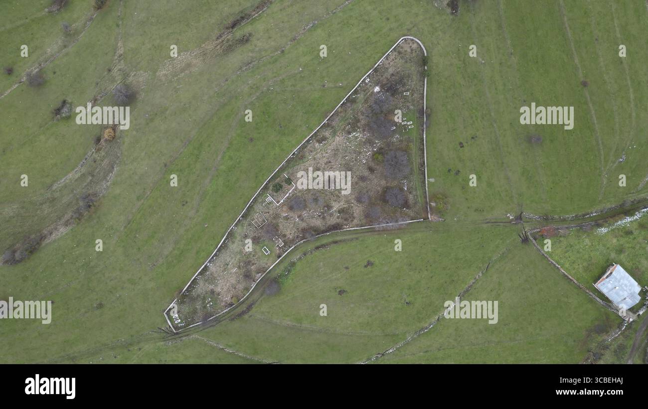 Aerial view of a triangular walled structure stands stark against the ...