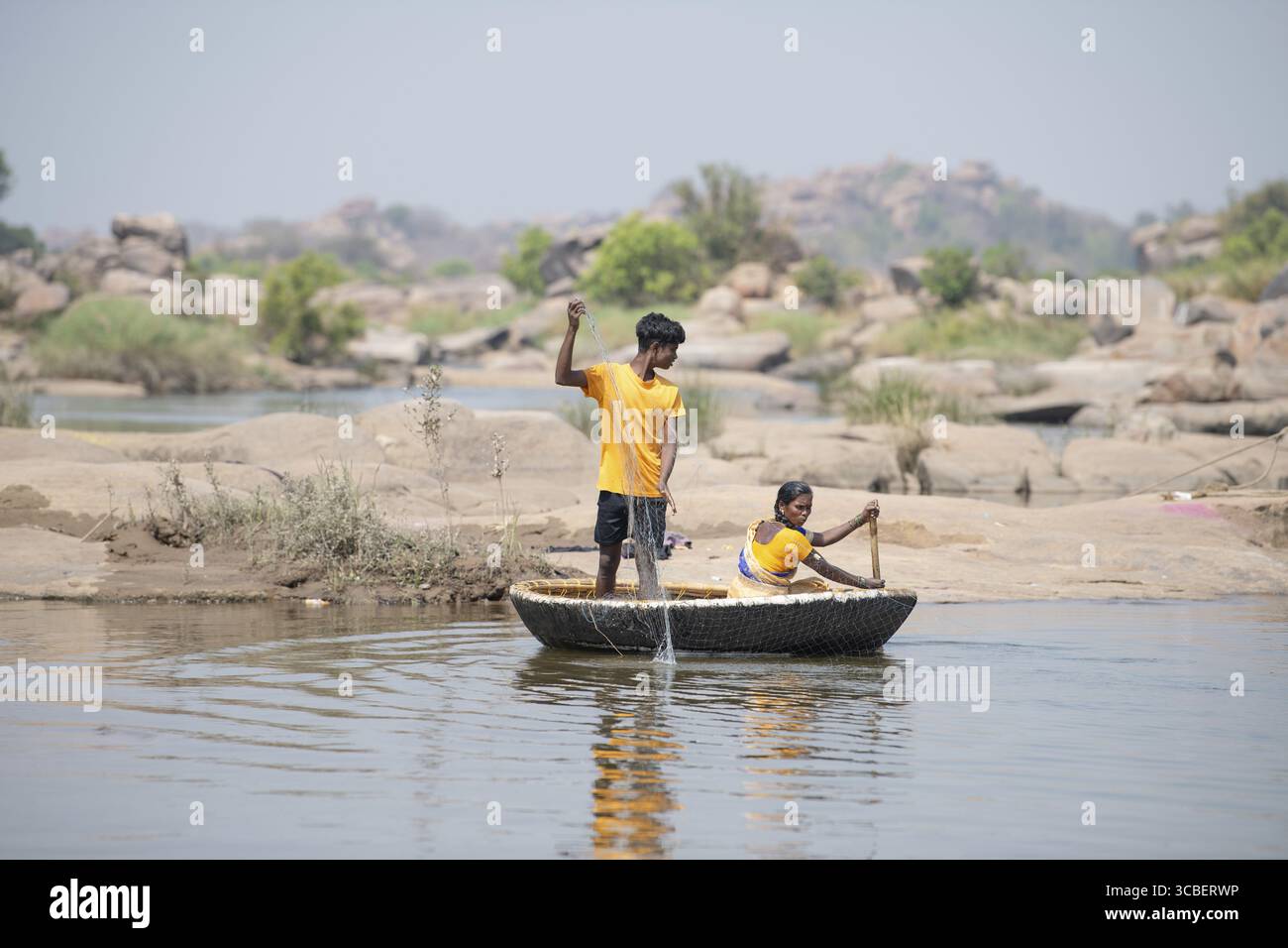 Fisher with coracle boat at Tungabhadra River in Hampi, India ...