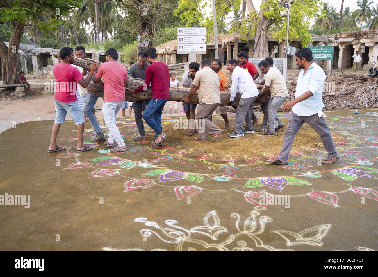 Holika Dahan, men collect wood for ritual bonfire, Kolam colorful ...
