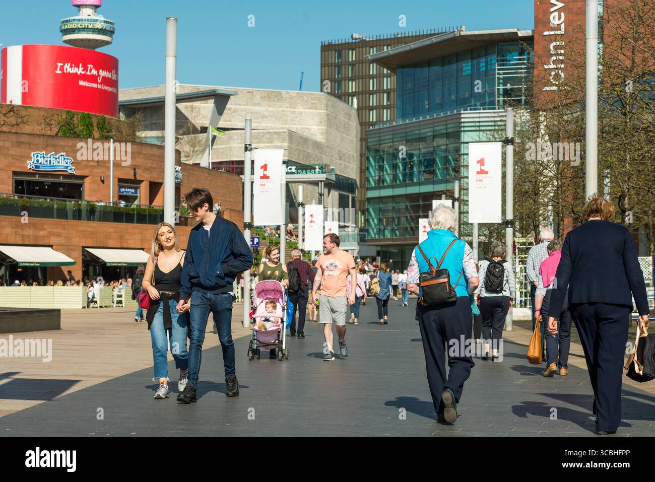 People walking through Liverpool One at Custom House Place on a warm ...