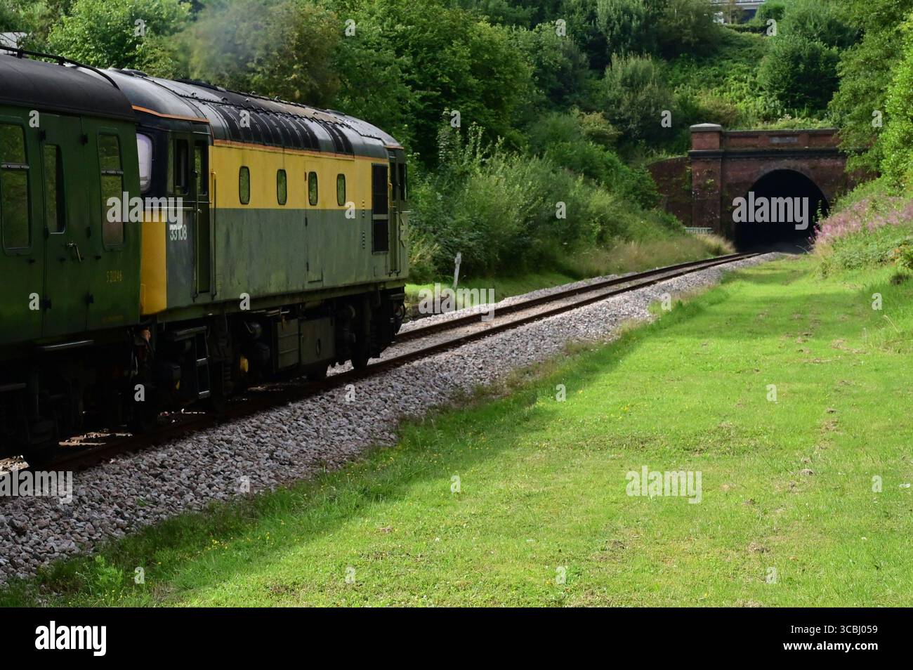 Class 33 vintage diesel locomotive pulling a passenger train Stock ...