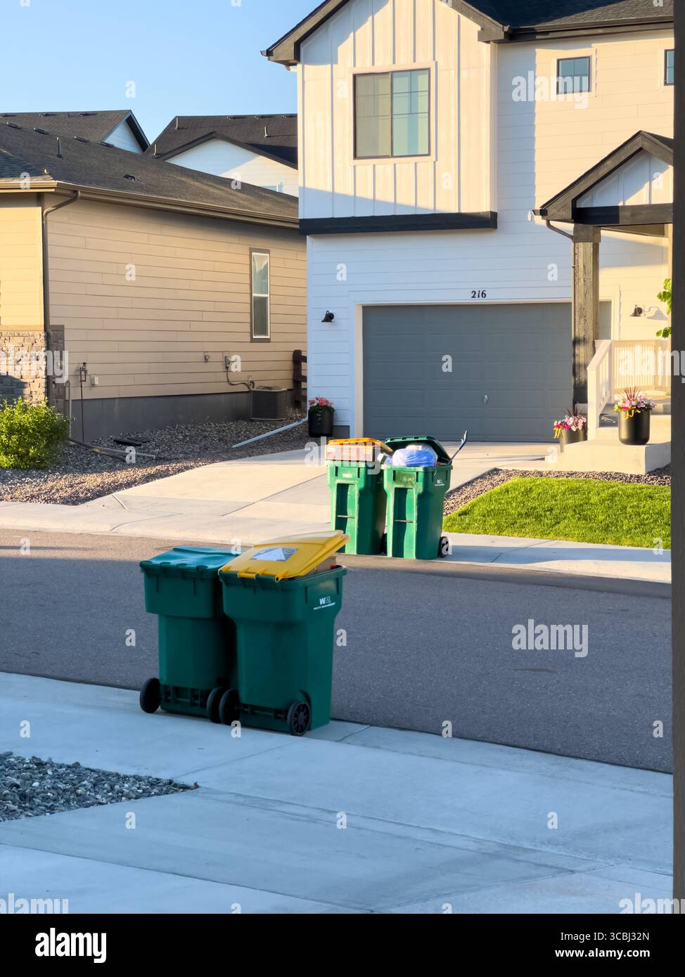 Green trash and recycle bins at curbside Stock Photo - Alamy