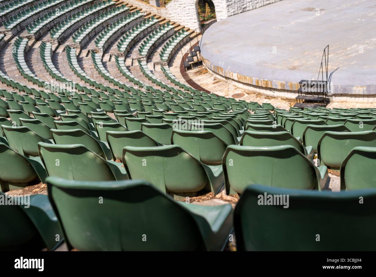 Amphitheater with concentric rows of tiered seating curving around a ...