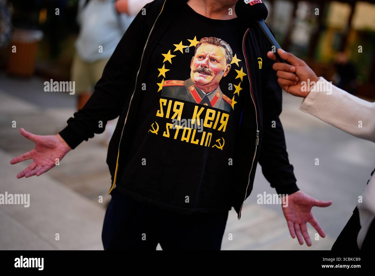 An anti-immigration protester, wearing a 'Sir Keir Stalin' tshirt ...
