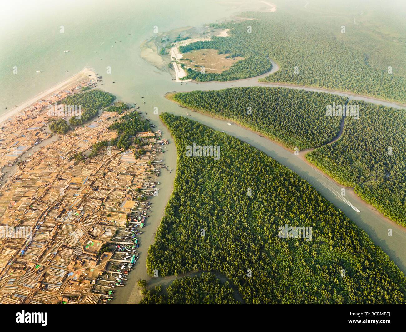 Aerial view of the confluence where the muted browns of dwellings meet ...