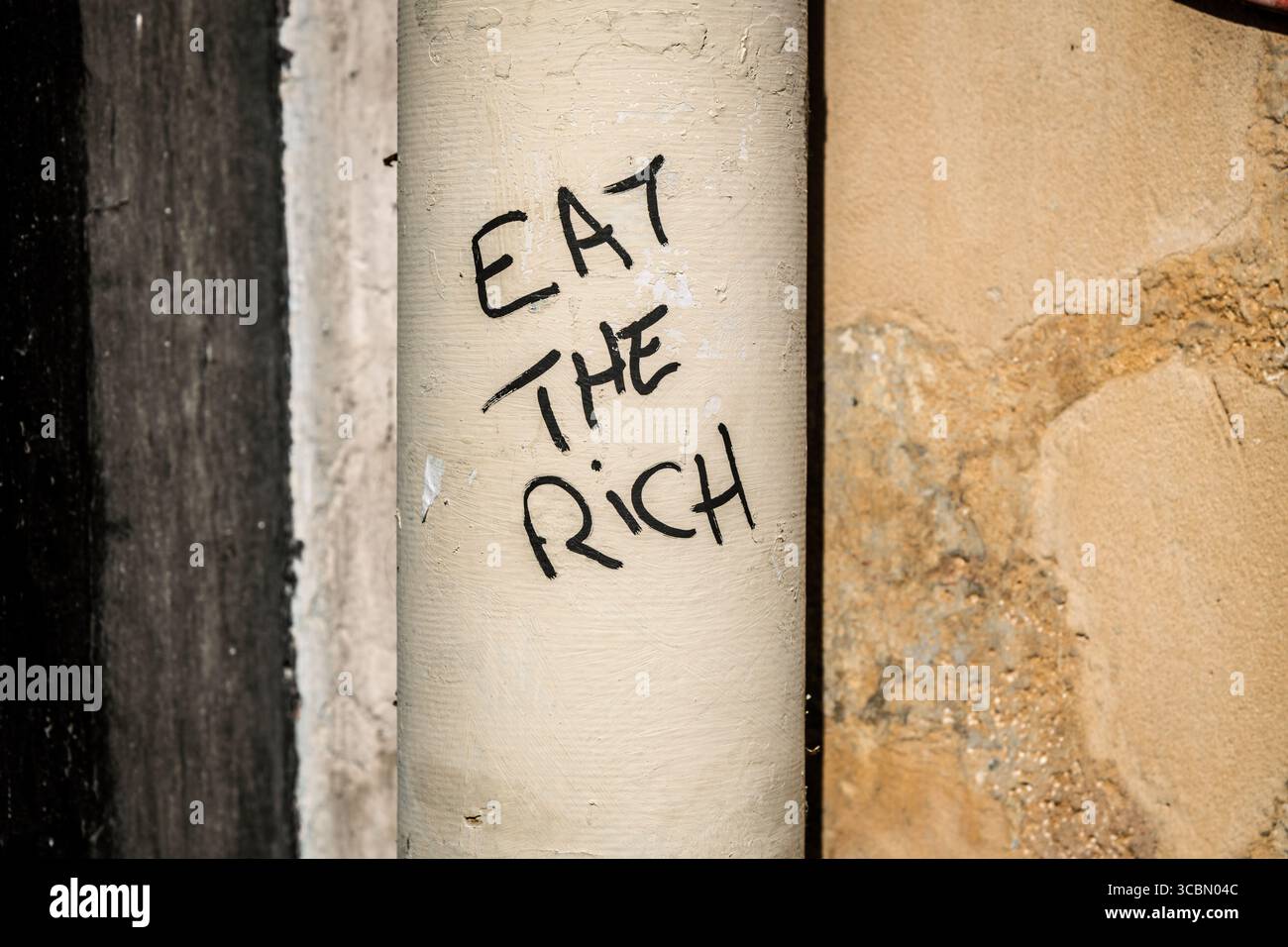 Eat The Rich graffiti Stock Photo - Alamy