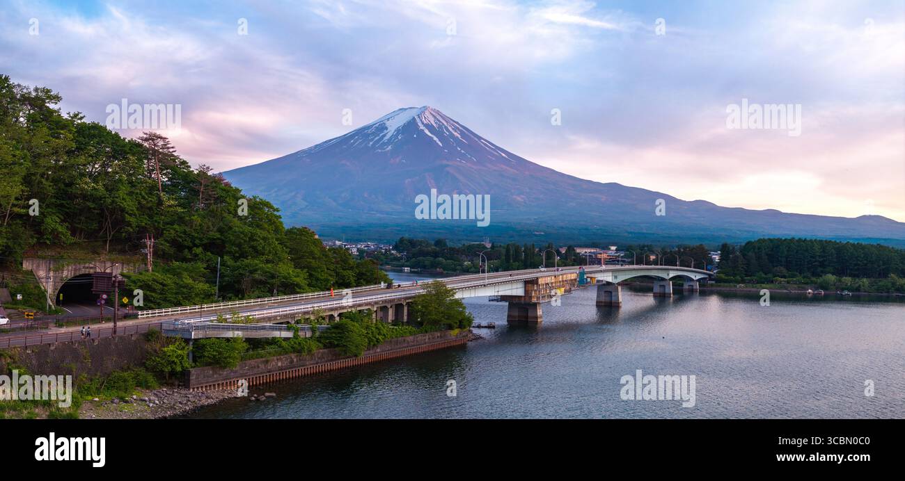 Aerial view of Mount Fuji's snow-capped peak rises serenely beyond the ...