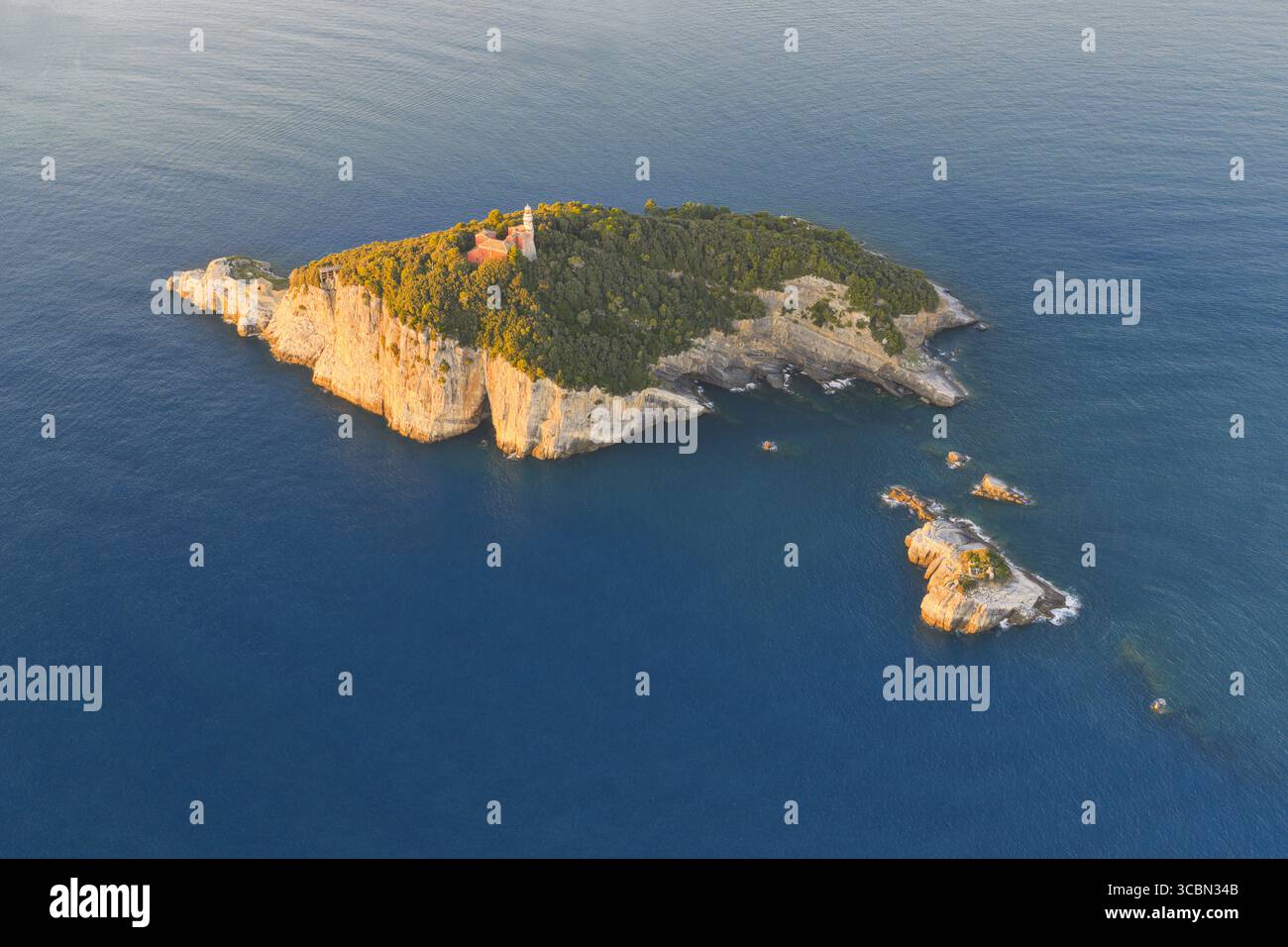 Aerial view of sunlit cliffs meet the deep blue sea, a rugged coastline ...
