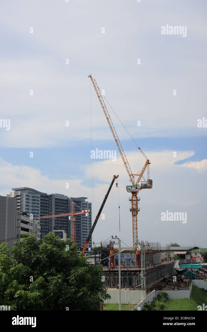 construction tower crane work with construction worker on top of ...