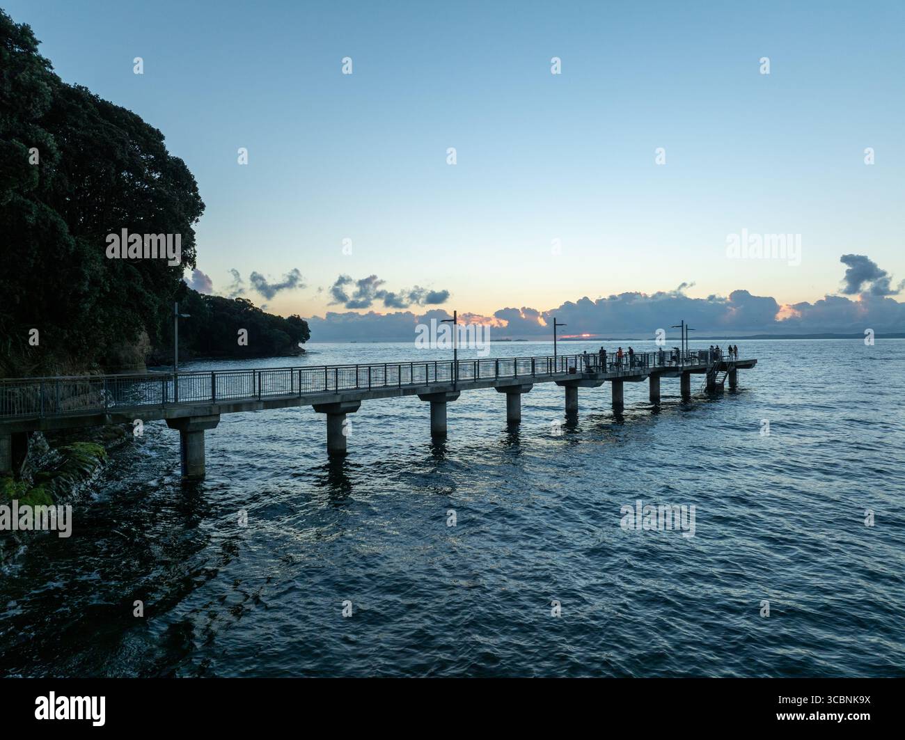 Aerial view of the pier jutting into the calm, rippling waters, a ...