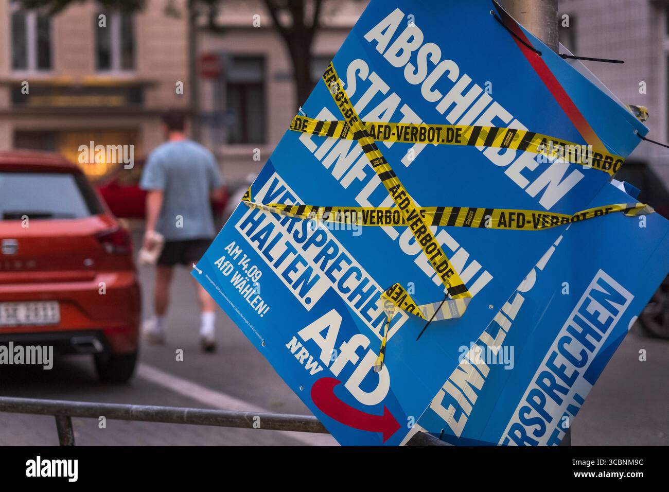 A torn AfD election poster for the 2025 local elections in NRW, covered ...