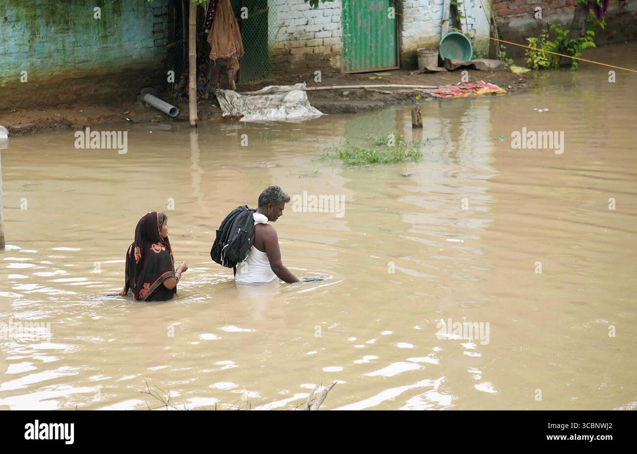 PATNA, INDIA - AUGUST 8: Flood victims crossing in flooded Ganga river ...