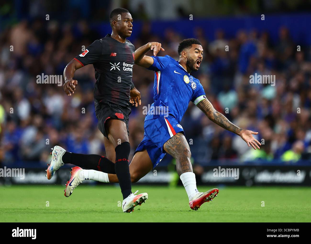 Josh Acheampong of Chelsea and Christian Kofane of Bayern Leverkusen ...