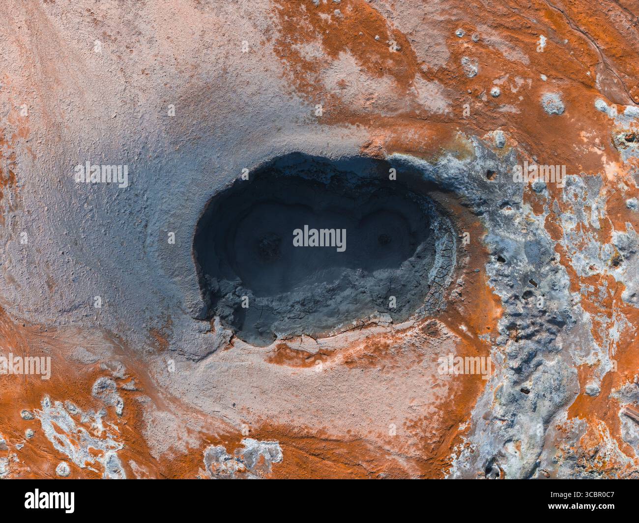 Aerial View of Geothermal Mud Pot with Vibrant Mineral Deposits in ...