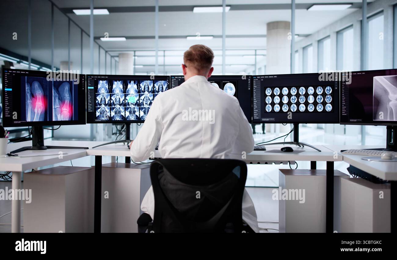 Doctor Examining Knee X-Ray On Computer Screen At Hospital Radiology ...