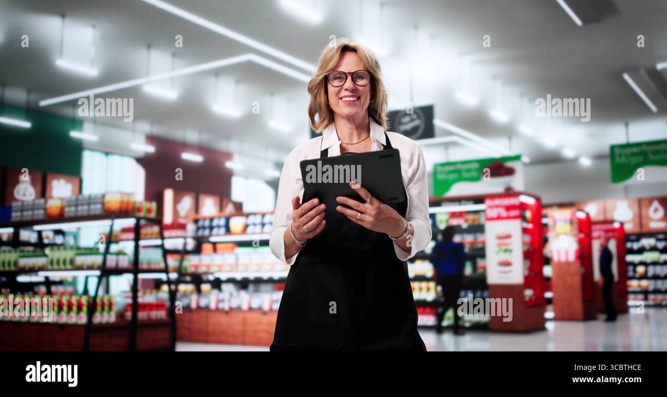 Smiling Lady Cashier Assisting Customers In Busy Supermarket Retail ...