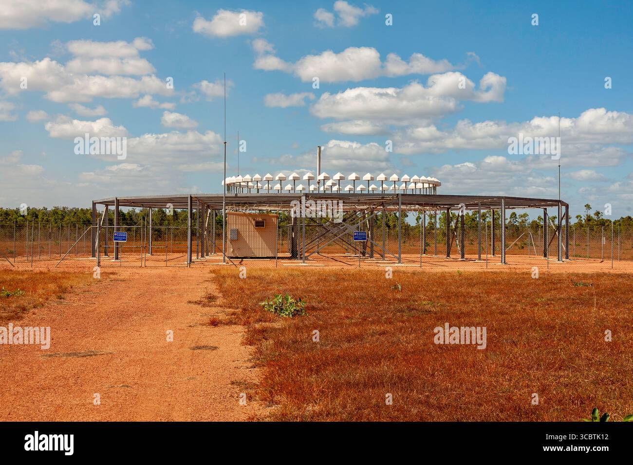 large round circle of dome white shaped cones inside security fence ...