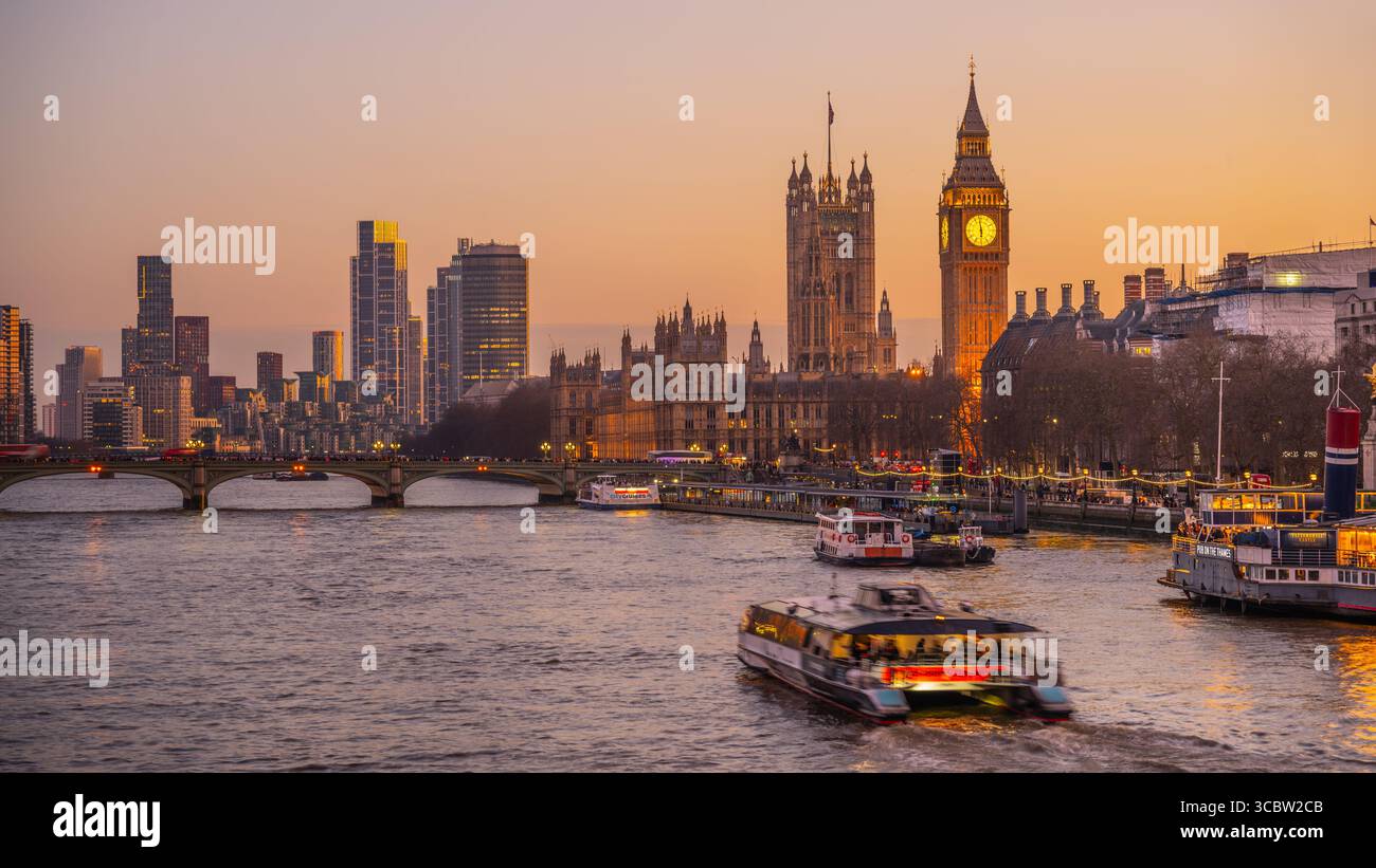 The River Thames glimmers at dusk as boats glide past. Big Ben and ...