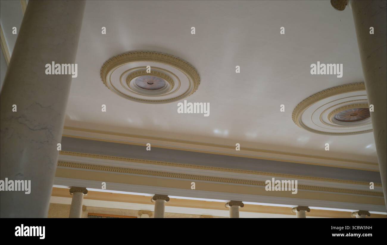Circular ceiling patterns and marble columns create an elegant ...