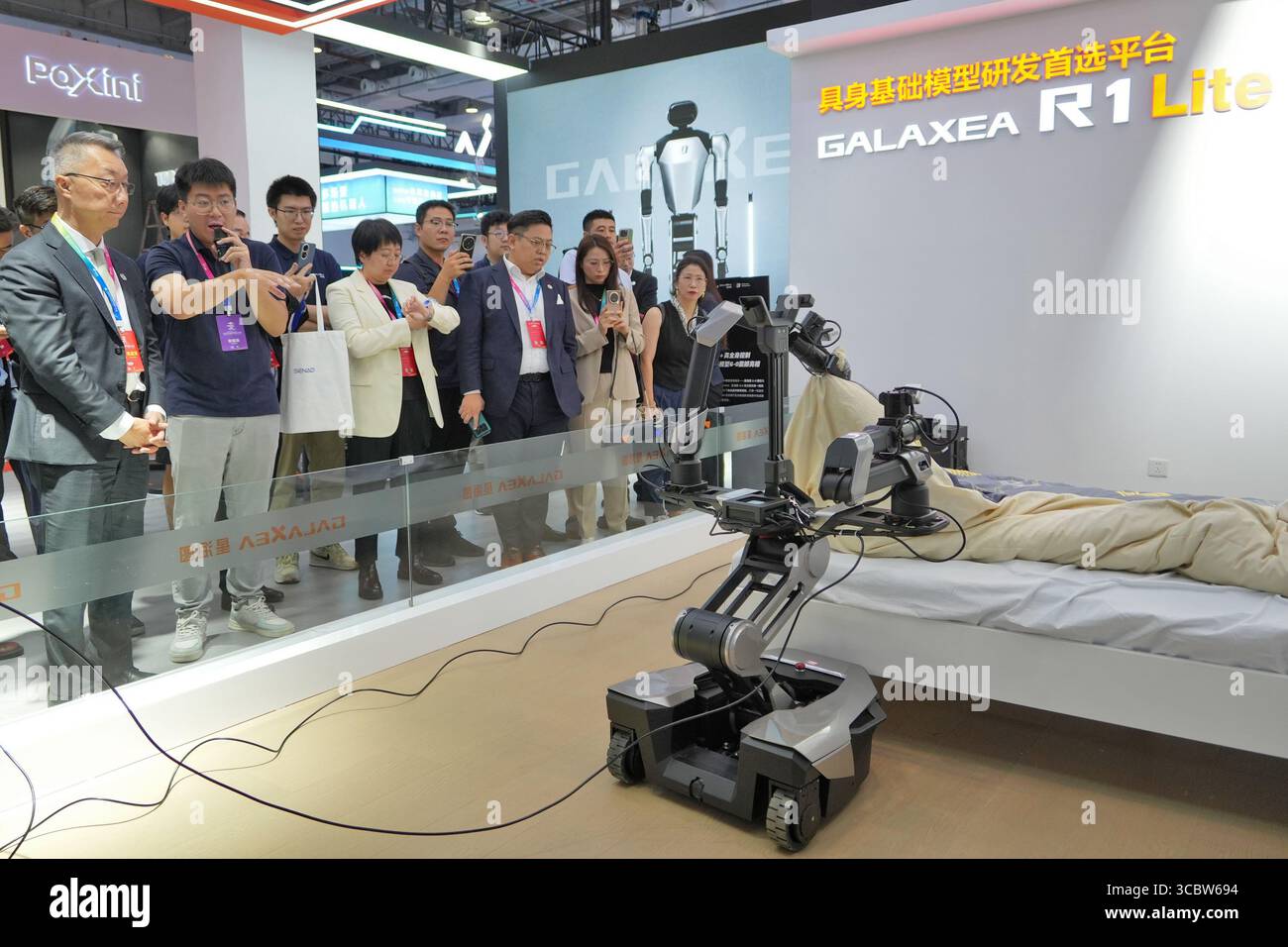 BEIJING, CHINA - AUGUST 8, 2025 - Viewers watch robots make beds at the ...