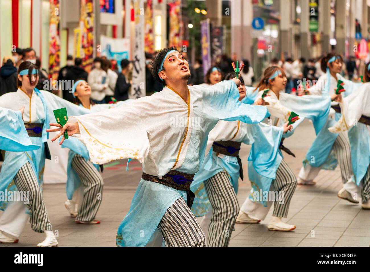 Close up of several Japanese yosakoi dancers holding naruko, wooden ...