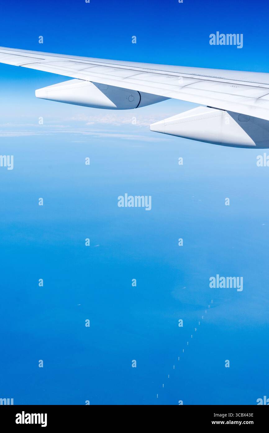Inflight view of the white wing of an airbus A350-900, flying above the ...