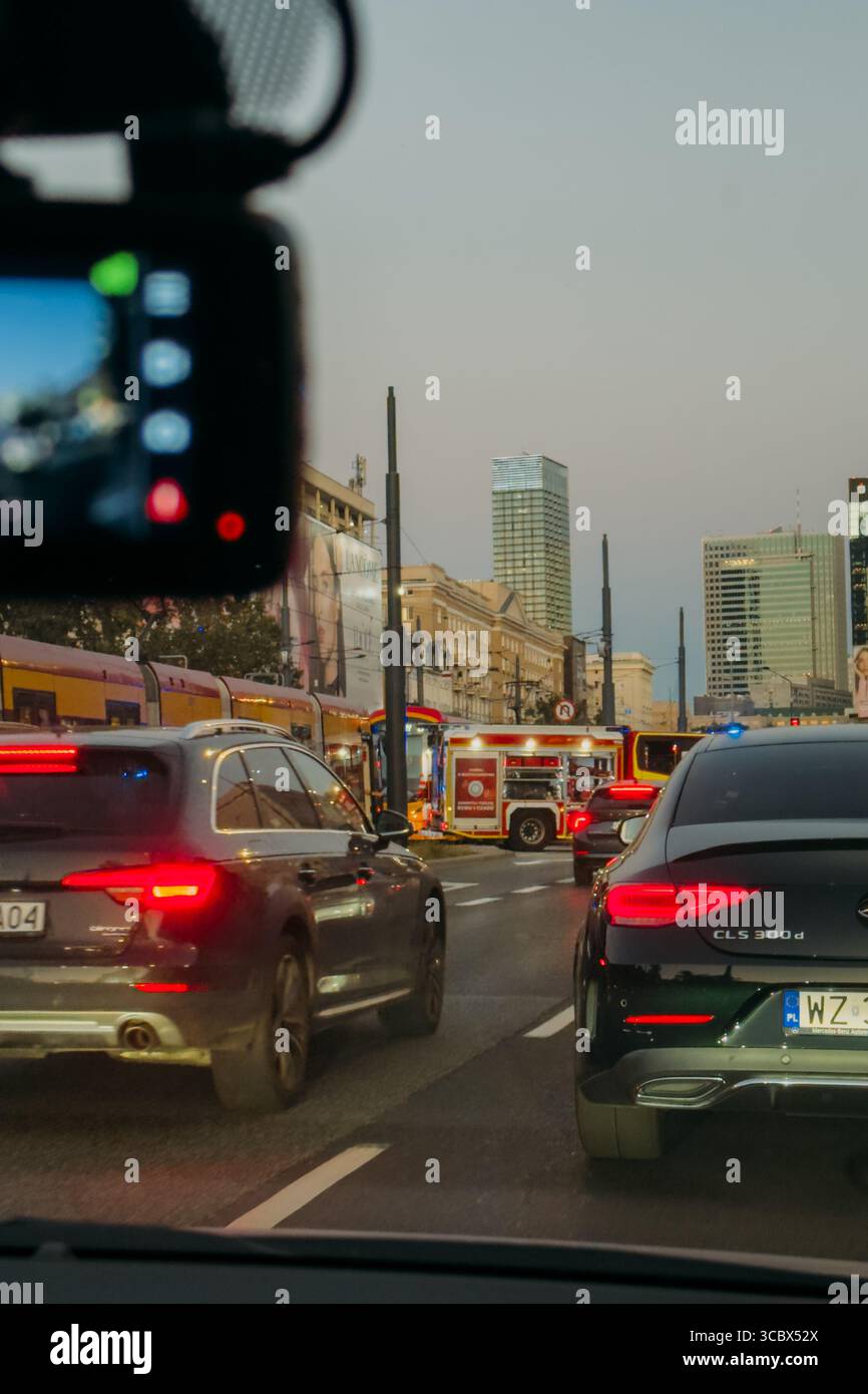 Urban traffic scene in Warsaw with emergency vehicles responding to an ...