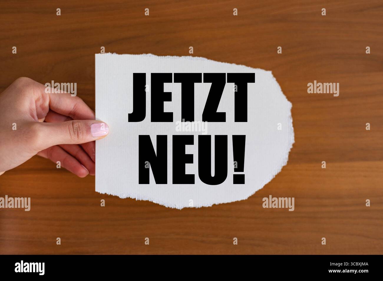 Jetzt neu Now new Jetzt neu Now new Woman hand holds a piece of paper ...