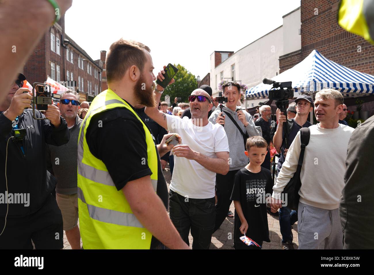 People gather at an anti-immigration protest outside Nuneaton and ...