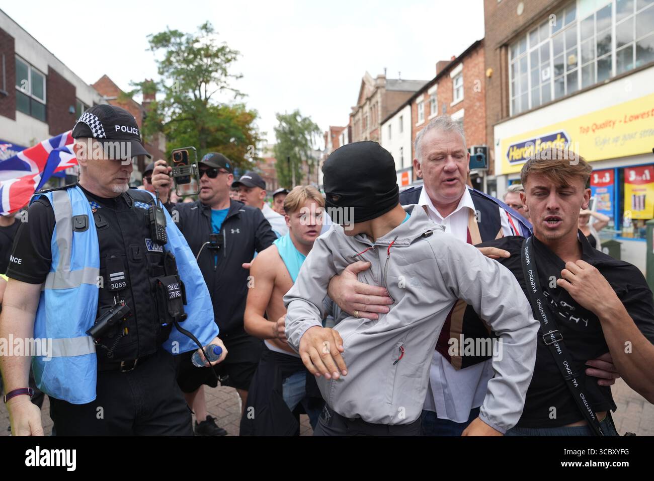 People and police officers during an anti-immigration protest in ...