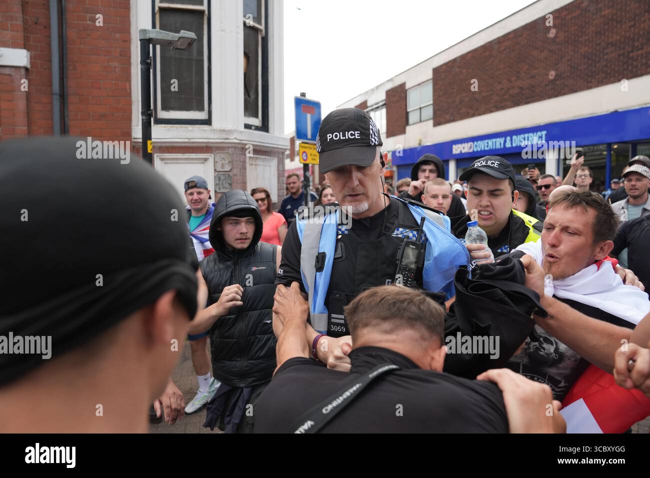 People and police officers during an anti-immigration protest in ...