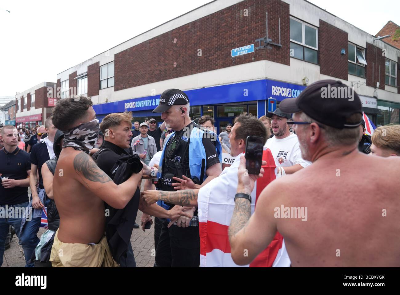 People and police officers during an anti-immigration protest in ...
