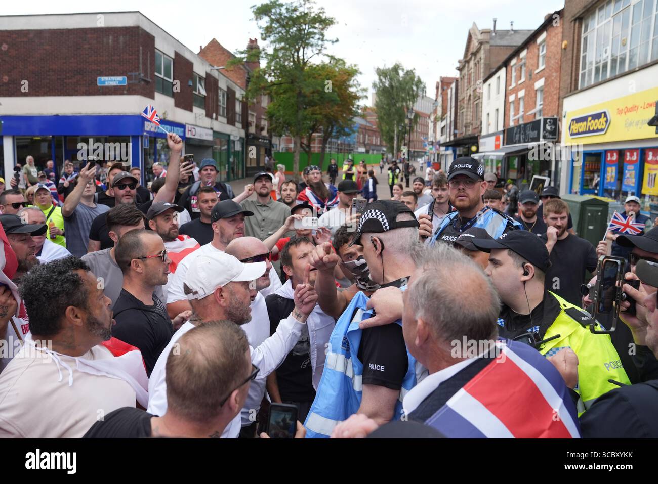 People and police officers during an anti-immigration protest in ...