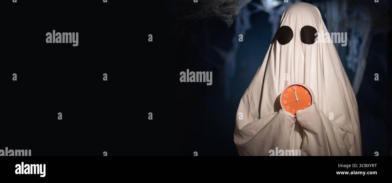 Halloween ghost in white sheet with black eyes holding alarm clock 12 ...