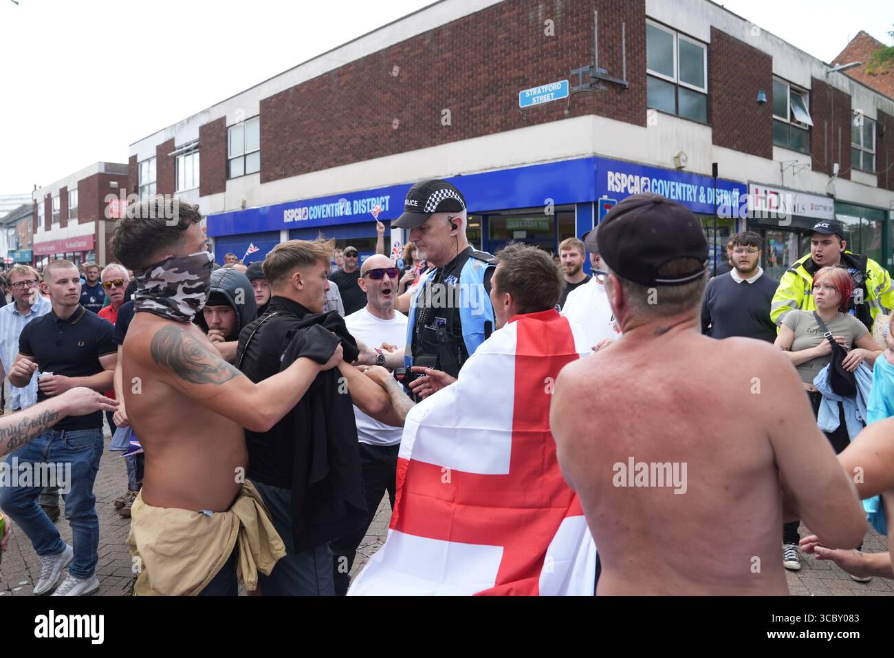 People and police officers during an anti-immigration protest in ...