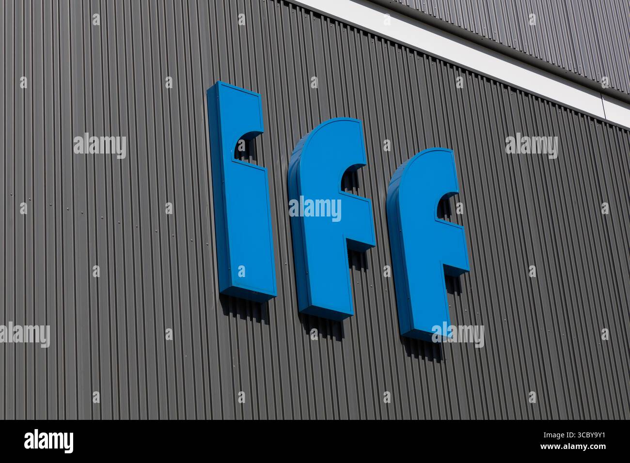 A detailed view of the vibrant blue IFF logo affixed to the modern ...