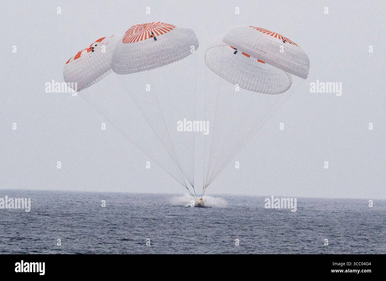 In this image provided by NASA, SpaceX capsule carrying four astronauts ...