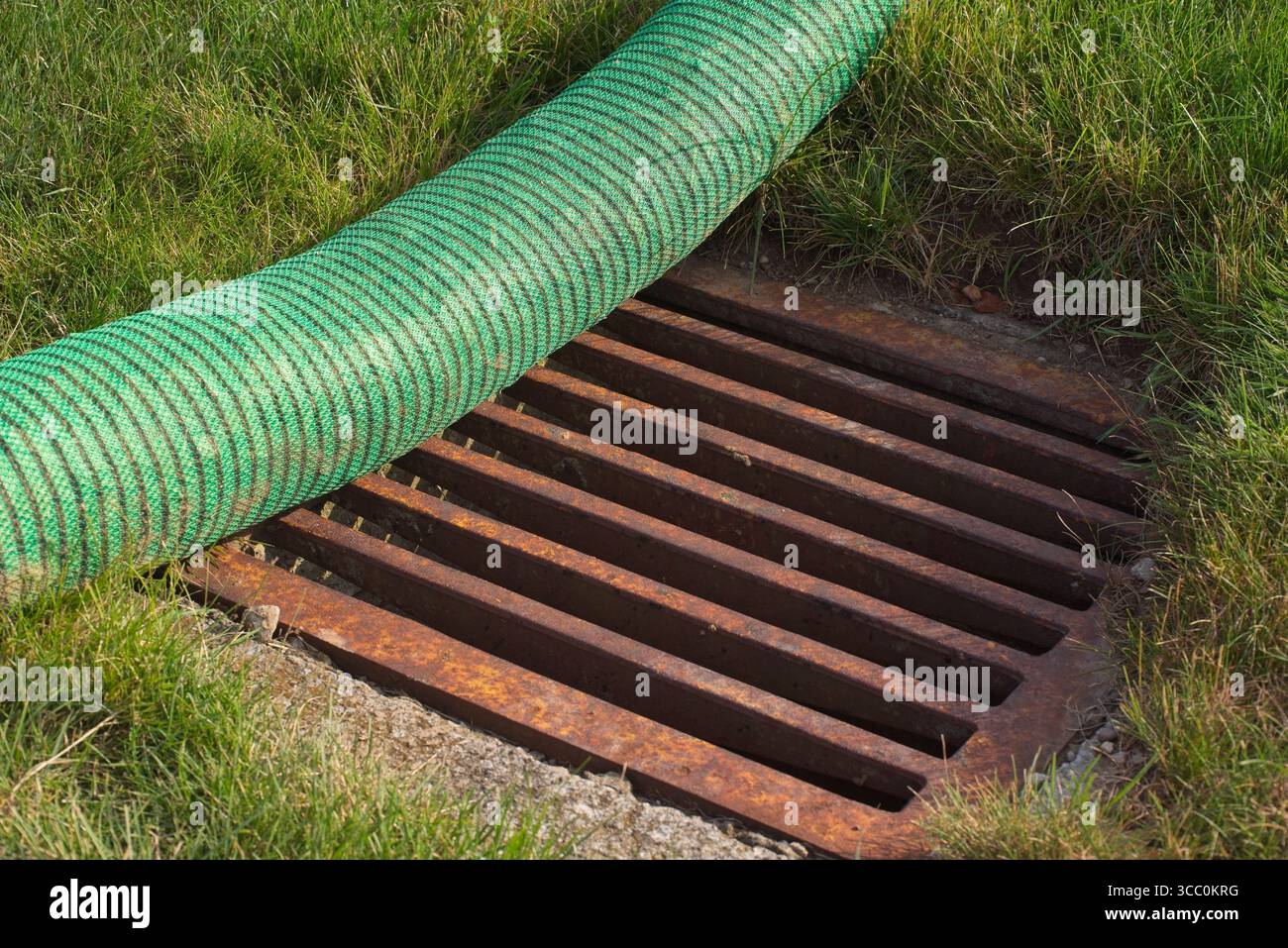 A flexible drainage tube at a town square construction site crosses the ...