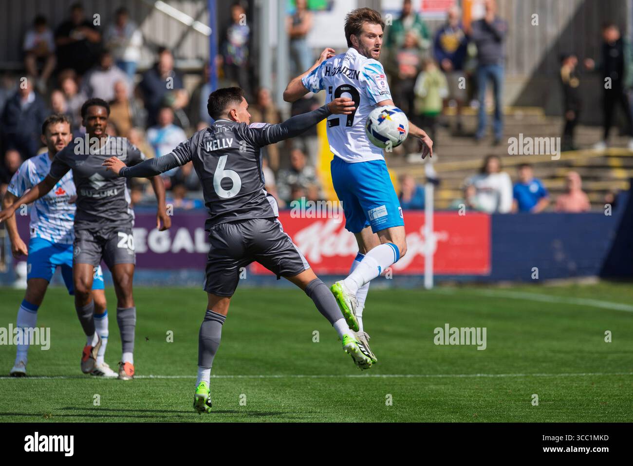 Barrow's Tom Barkhuizen challenges for a header with MK Dons' Liam ...
