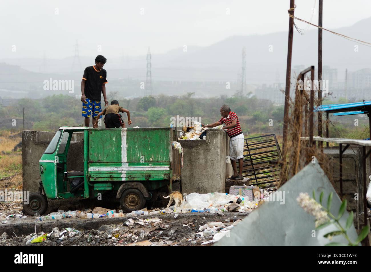 Men scavenging at a garbage dump, rural India Stock Photo - Alamy
