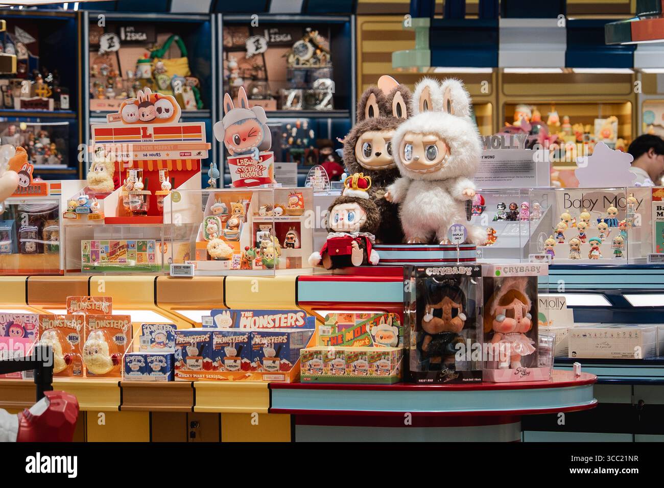 A close-up display inside the POP MART flagship store features an array ...