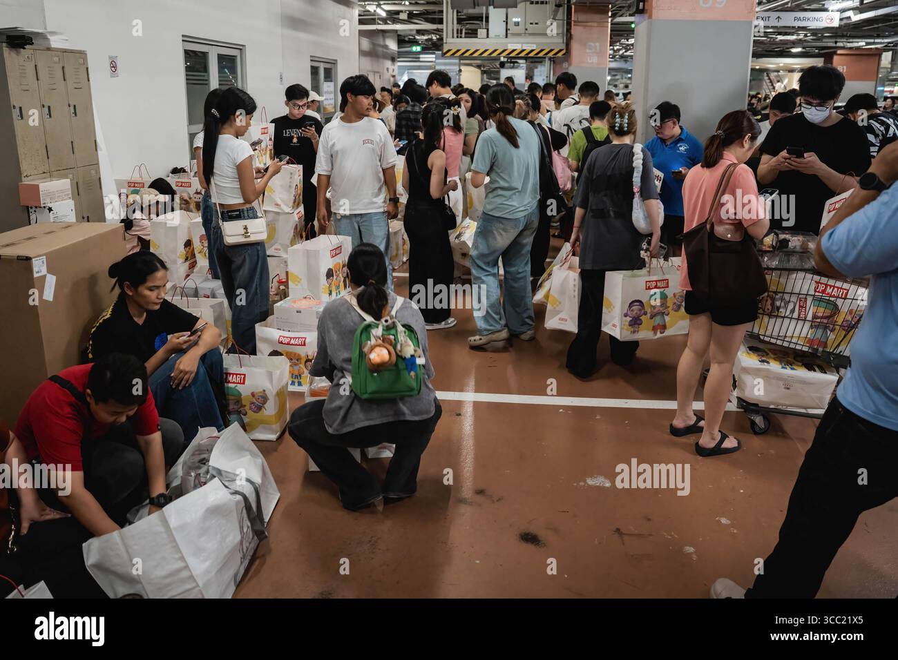 Shoppers with POP MART bags seen at a pickup point set up in the ...
