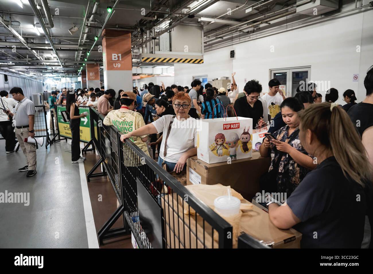 Bangkok, Thailand. 9th Aug, 2025. Shoppers queue with POP MART bags ...