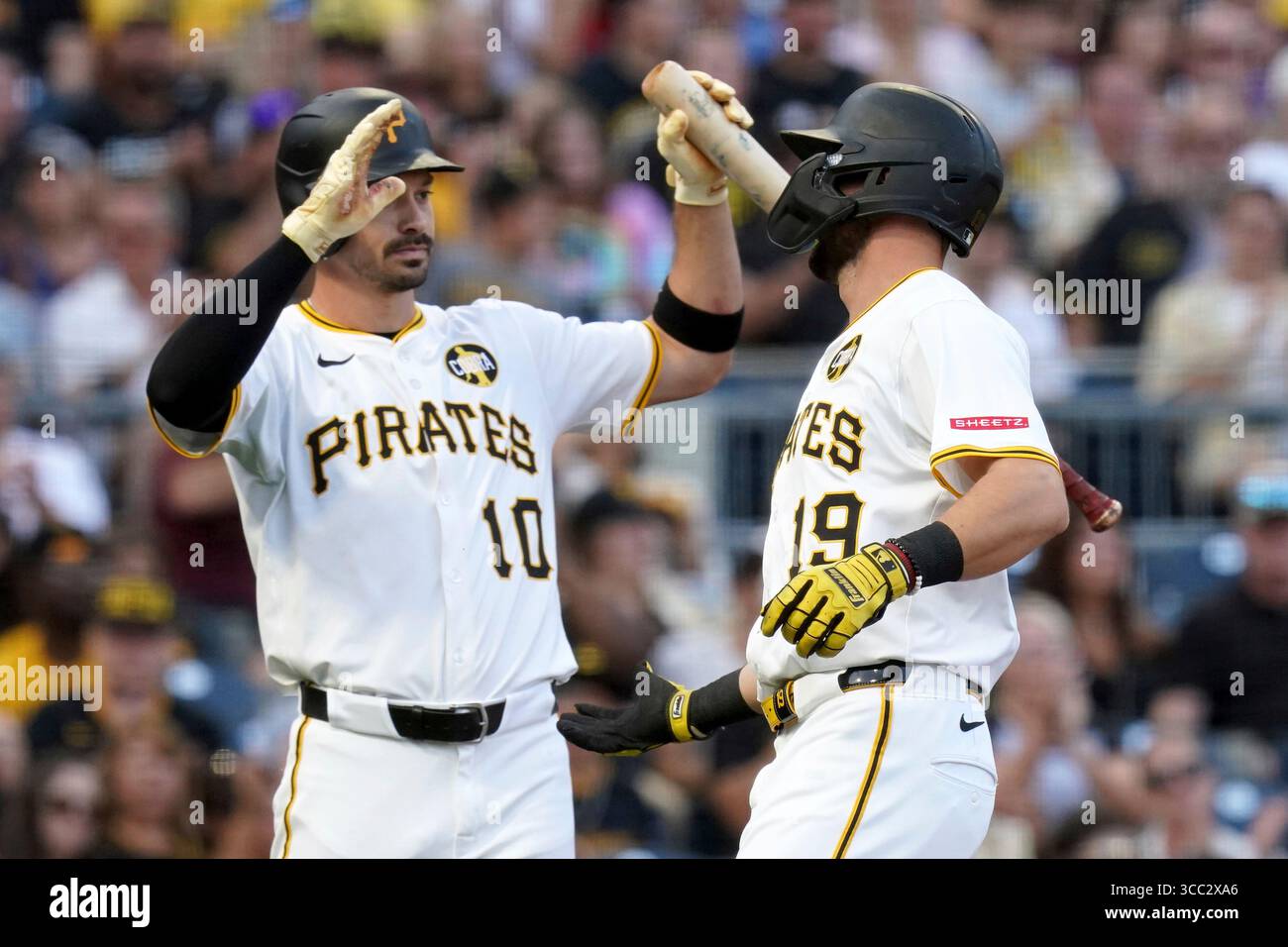 Pittsburgh Pirates' Jared Triolo, right, is greeted by Bryan Reynolds ...