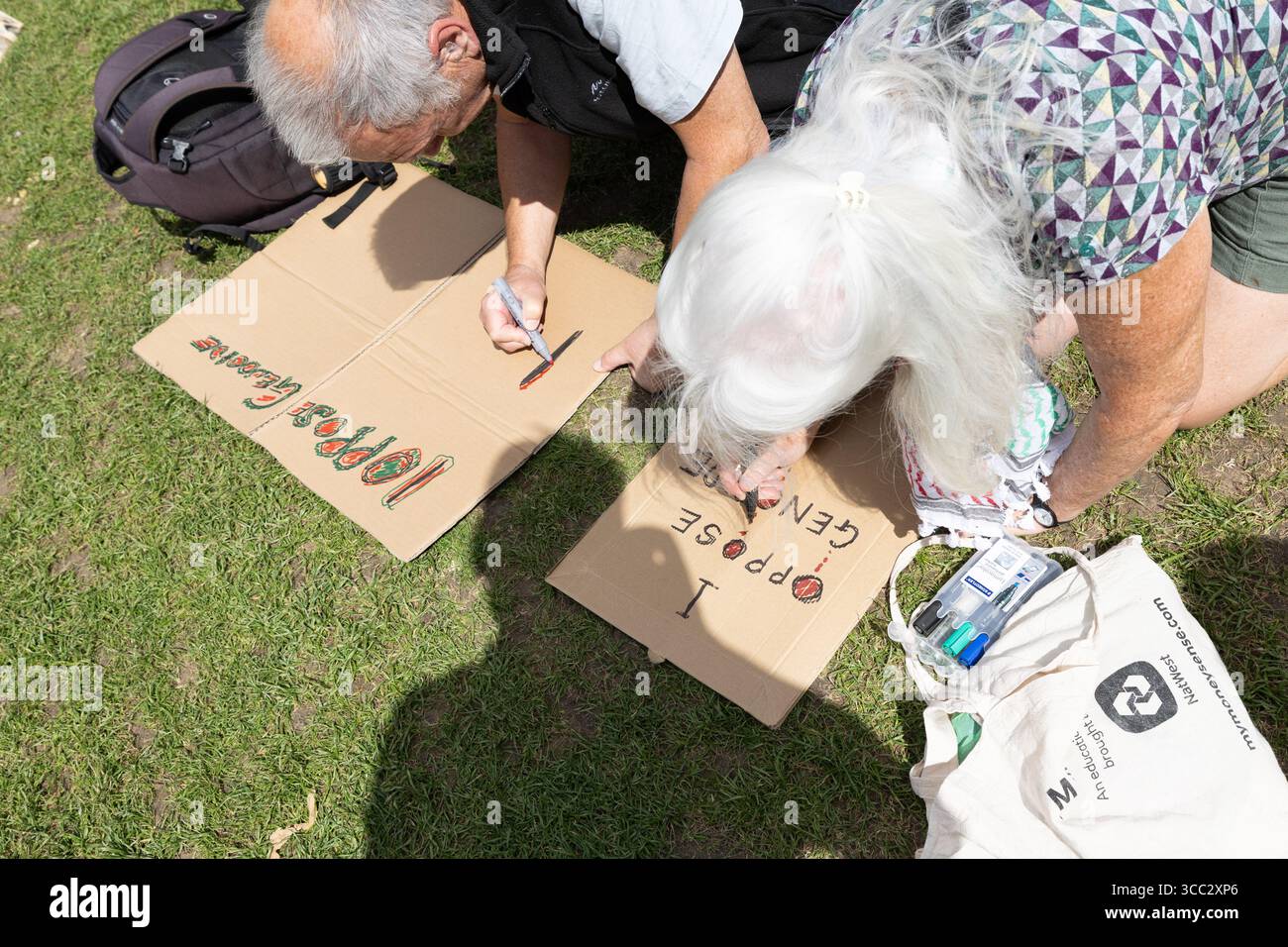 Activists write signs reading 'I oppose genocide, I support Palestine ...