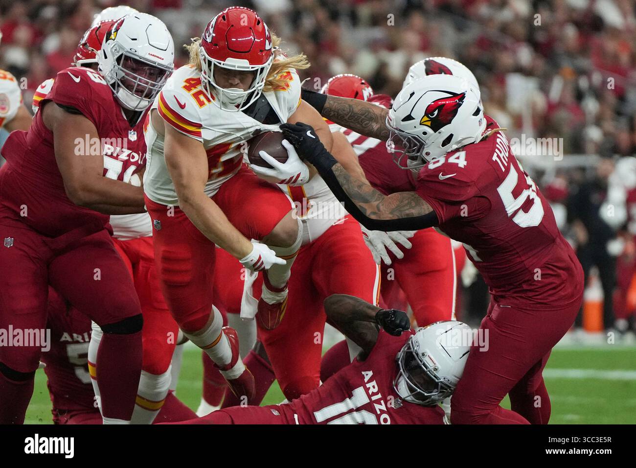 Kansas City Chiefs fullback Carson Steele (42) breaks the tackles of ...