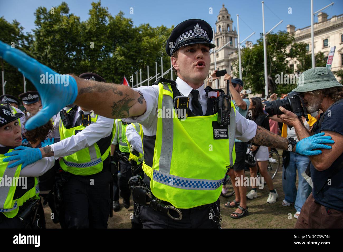 A Metropolitan Police Officer directs the crowd to move during the ...